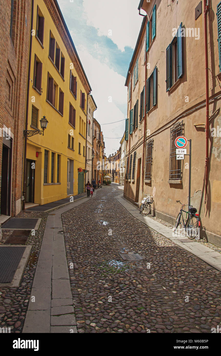 Ferrara, Italy - May 11, 2013. People walking by alley in the historic ...