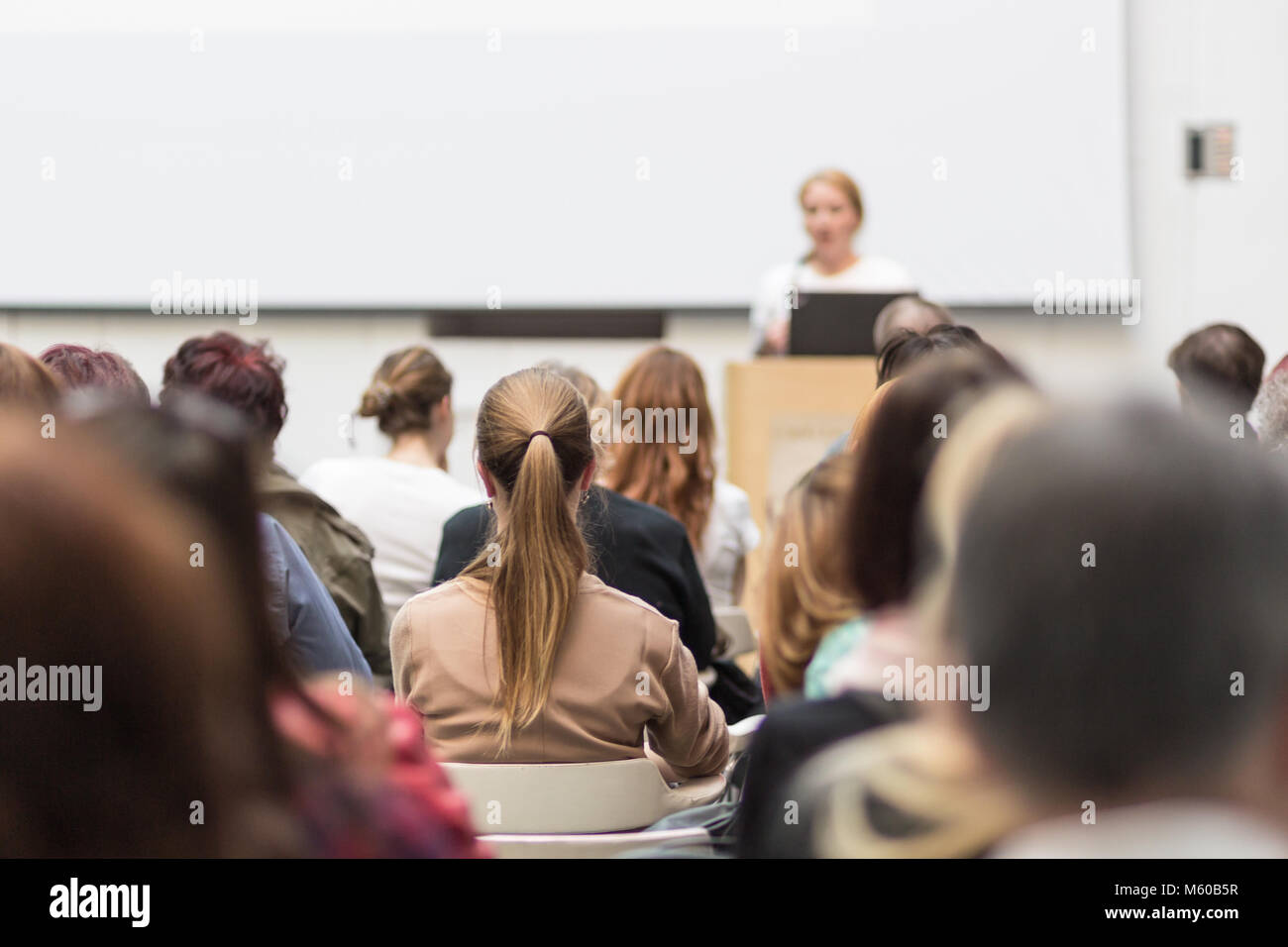 Woman giving presentation on business conference Stock Photo - Alamy