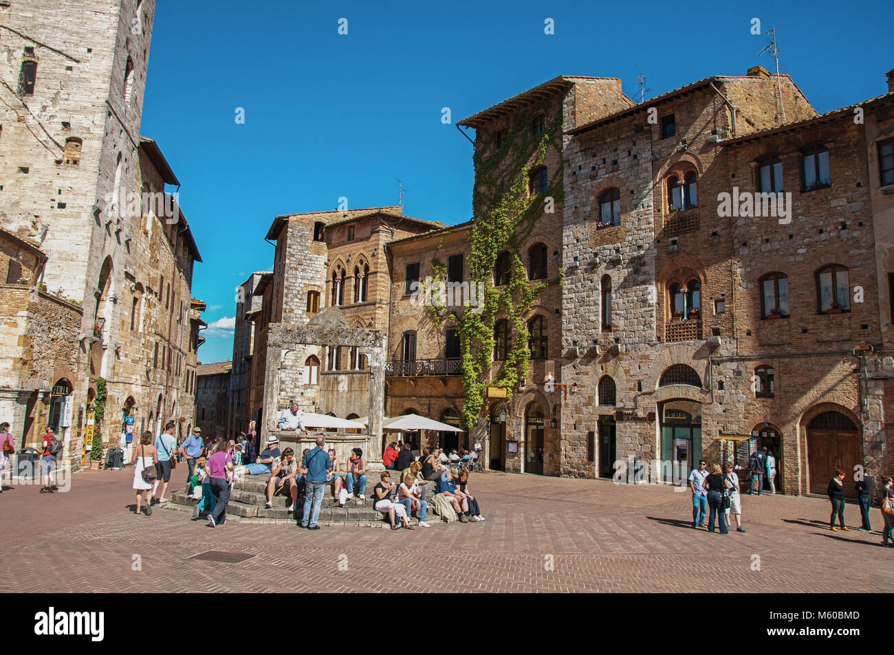San Gimignano, Italy. View of square with people, old buildings in San ...