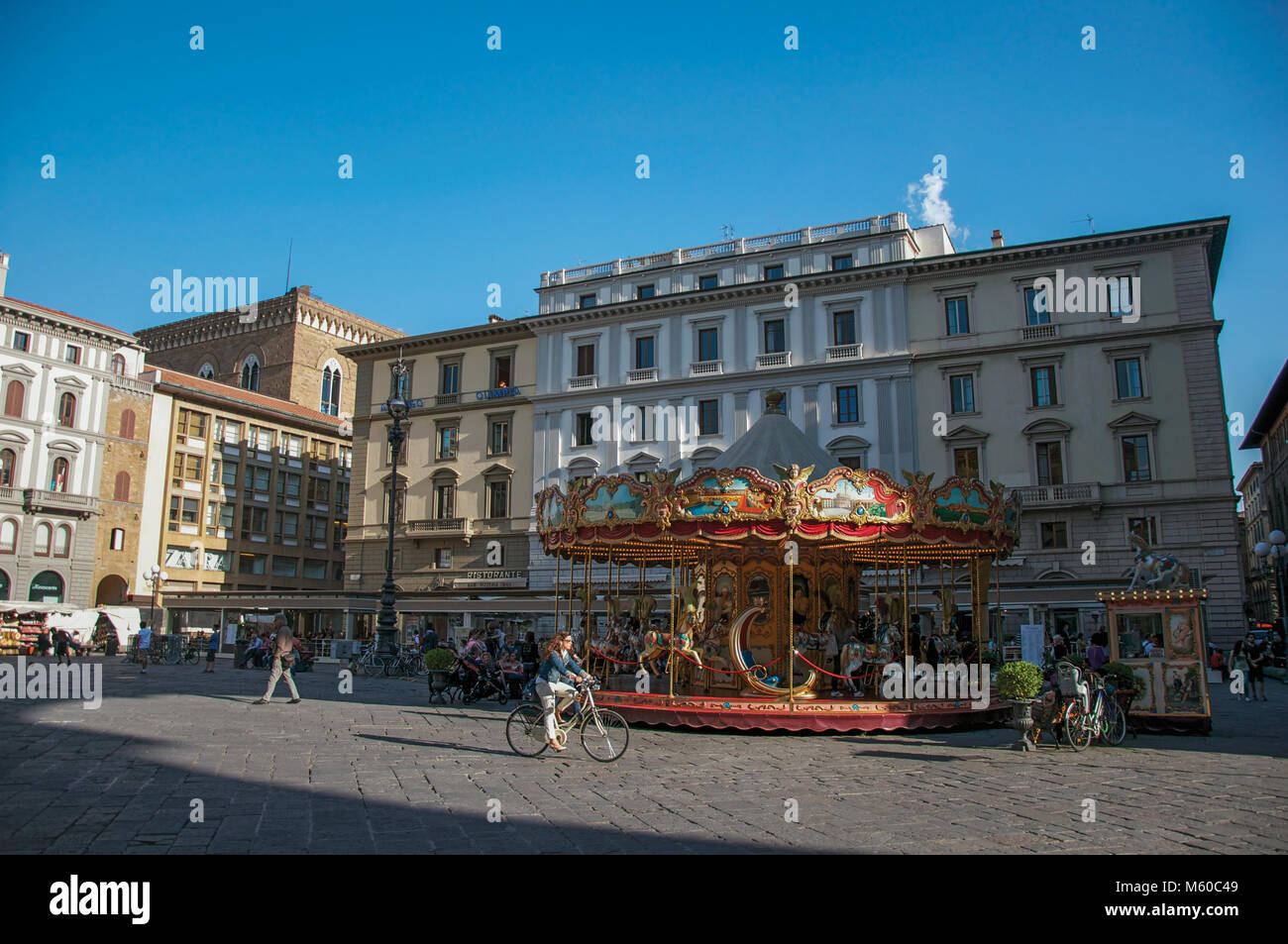 Florence, Italy. View of square with buildings, people and carousel at ...