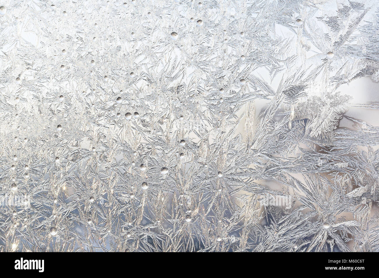Frost patterns at window glass. Closeup Stock Photo - Alamy