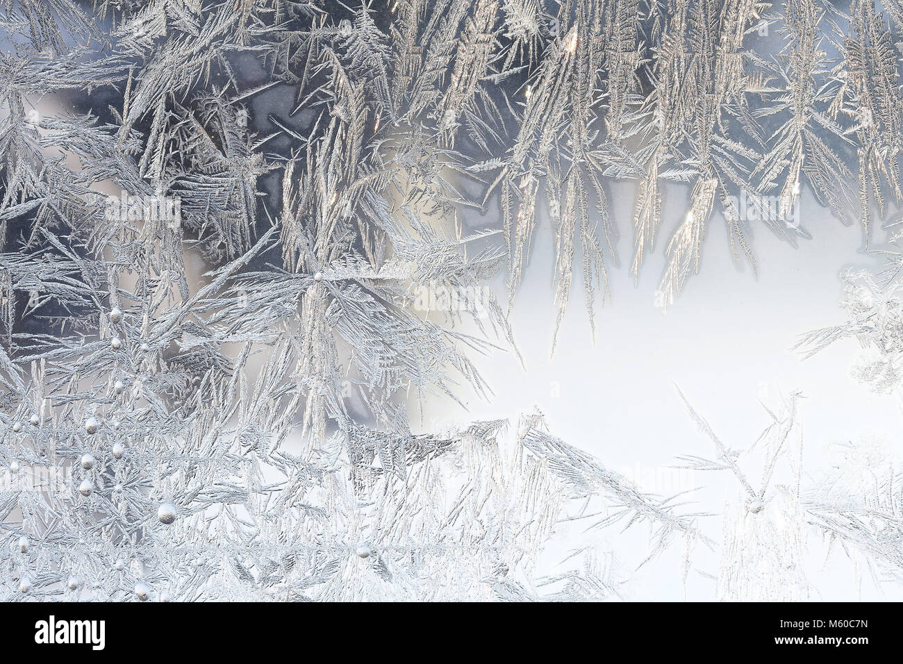Frost patterns at window glass. Closeup Stock Photo - Alamy