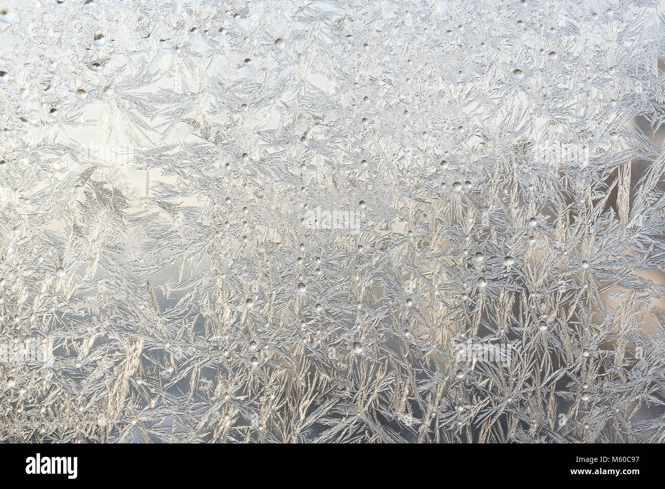 Frost patterns at window glass. Closeup Stock Photo - Alamy