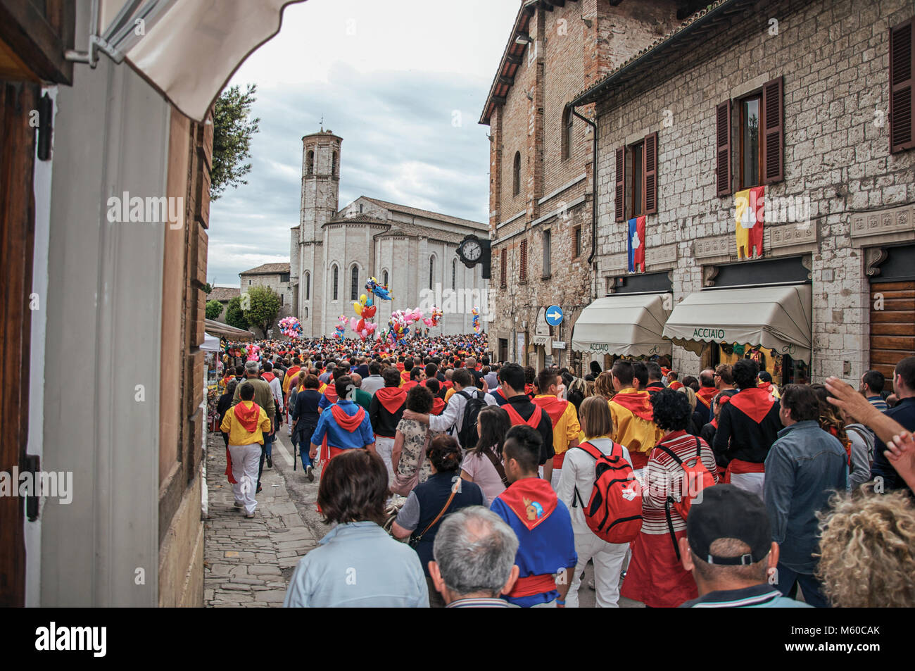 Gubbio, Italy. Colorful crowd participating in the "Feast of Ceri", a ...