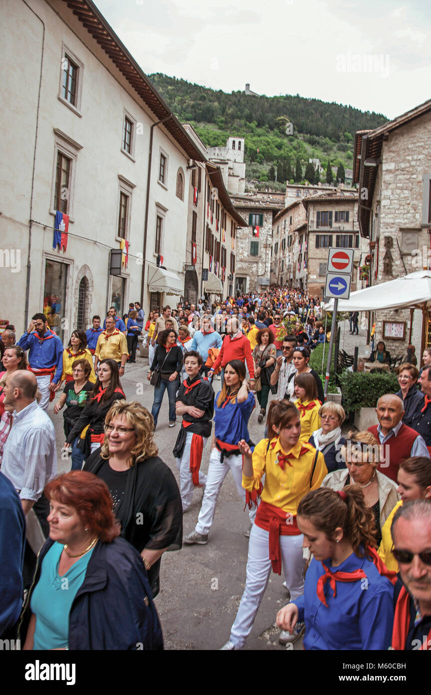 Gubbio, Italy. Colorful crowd participating in the "Feast of Ceri", a ...