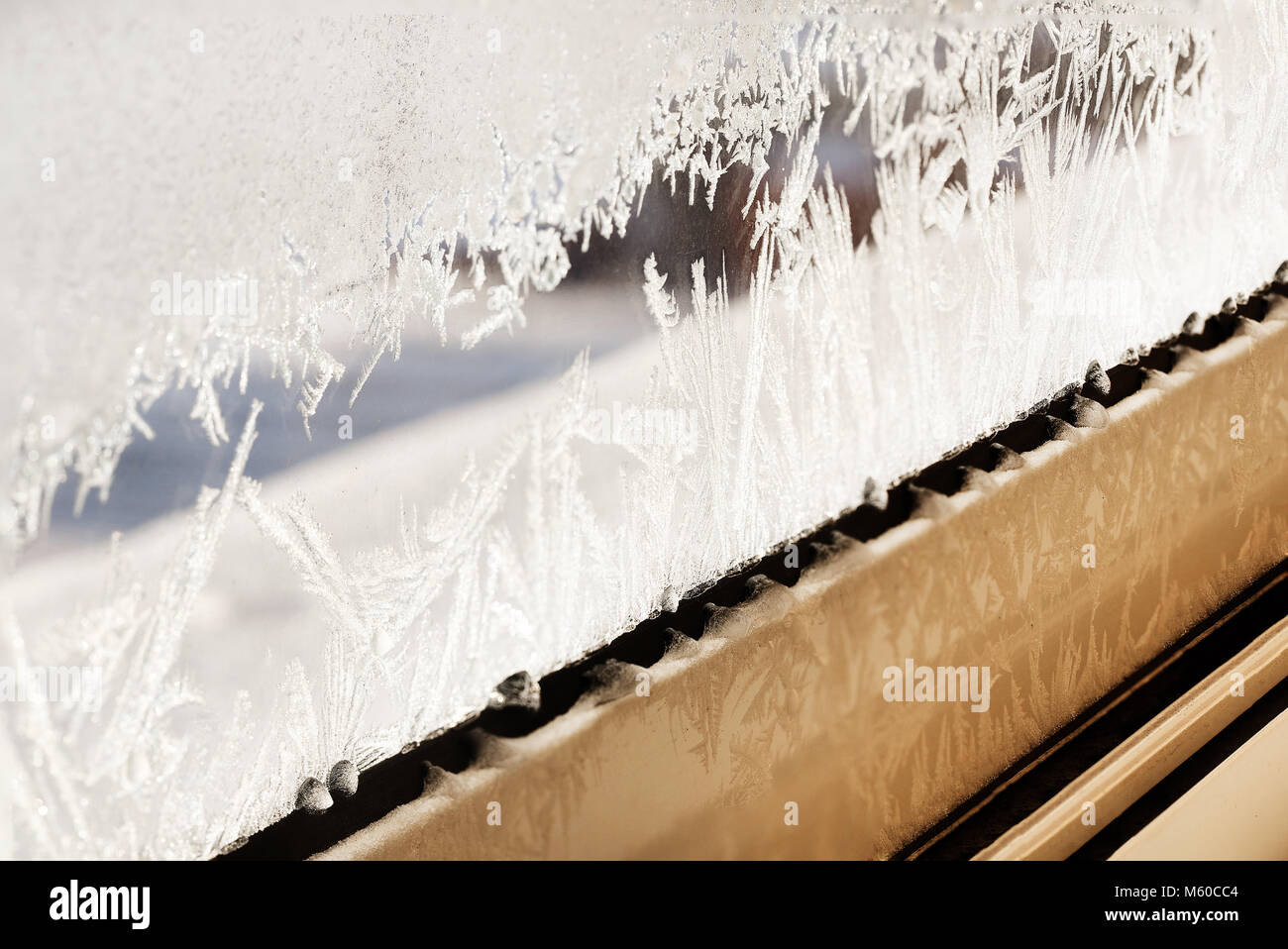 Frost patterns at window glass. Closeup Stock Photo - Alamy