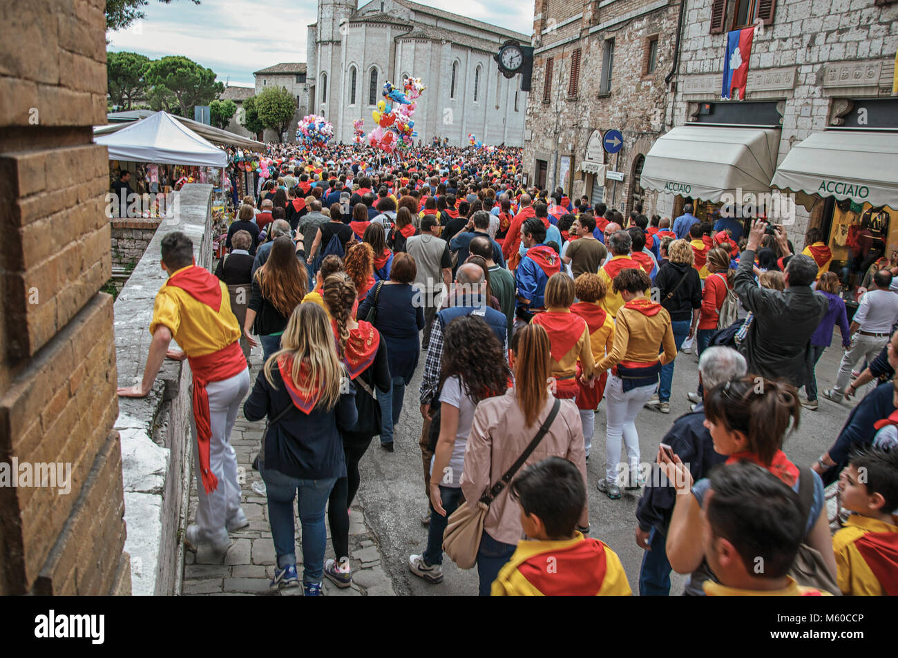 Gubbio, Italy. Colorful crowd participating in the "Feast of Ceri", a ...