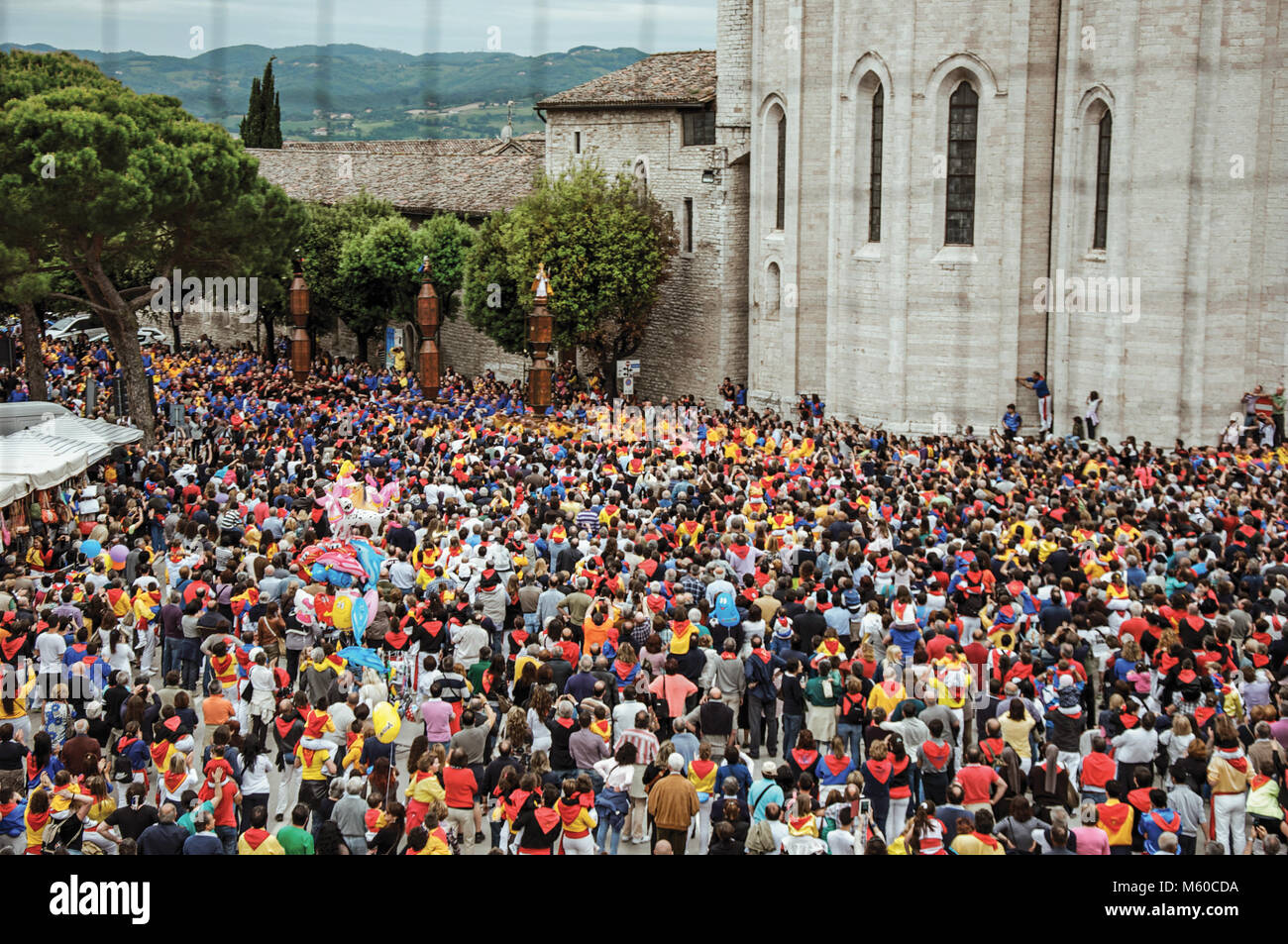 Gubbio, Italy. Colorful crowd participating in the "Feast of Ceri", a ...