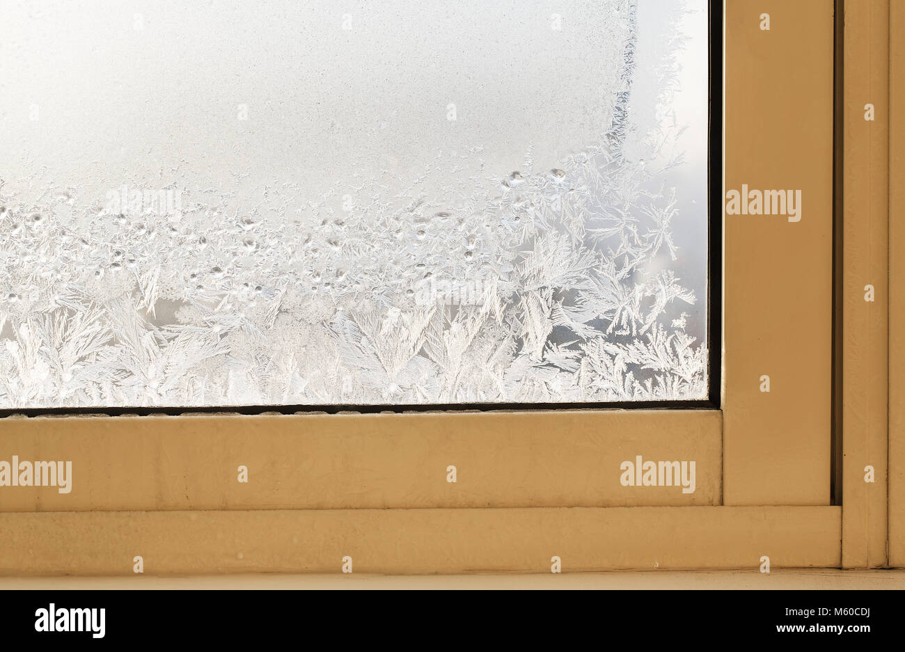 Frost patterns at window glass. Closeup Stock Photo - Alamy