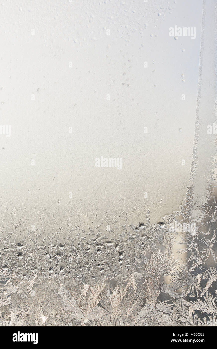 Frost patterns at window glass. Closeup Stock Photo - Alamy