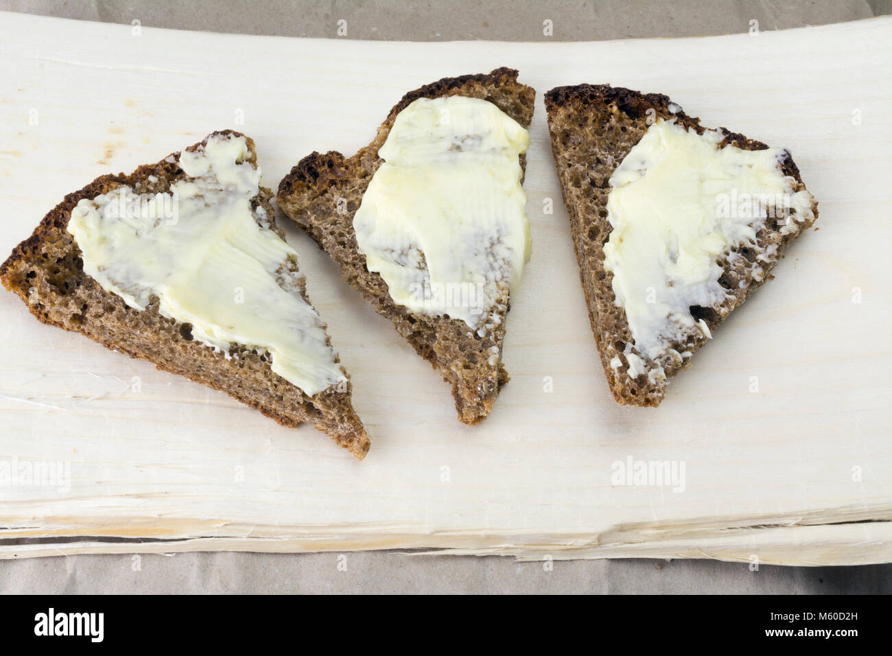 Finnish rye bread slices with butter on wooden shingle Stock Photo - Alamy