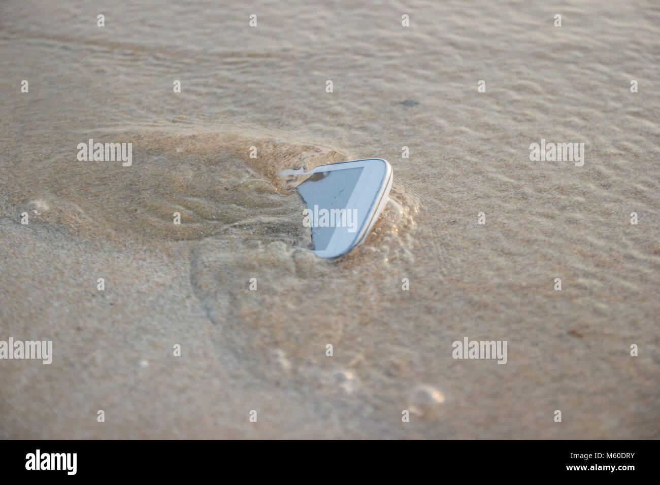 Mobile phone floated to the sea at the beach. Mobile phone floated to ...