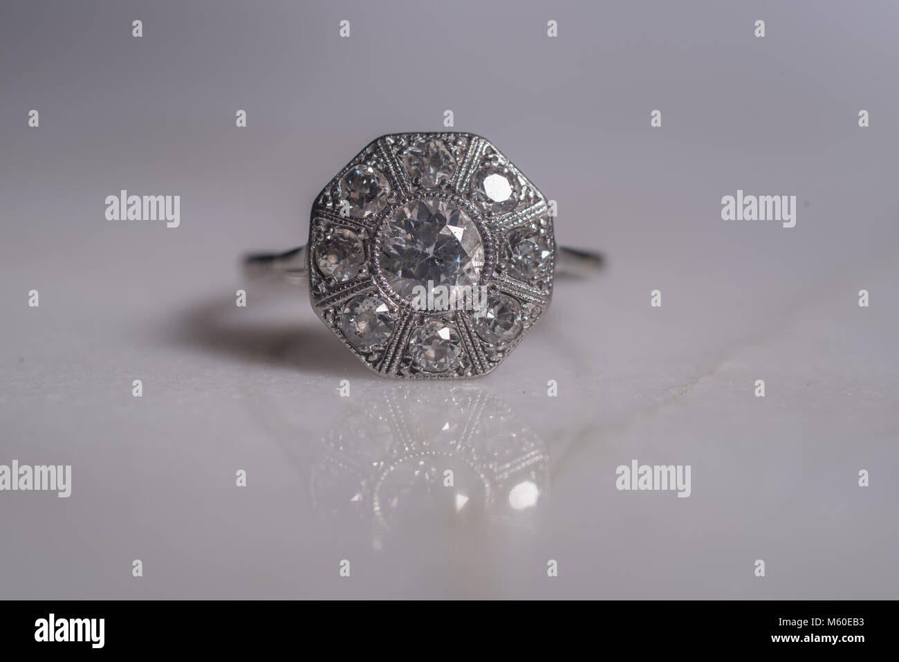 A picture of a womens platinum and diamond engagement ring on a marble ...