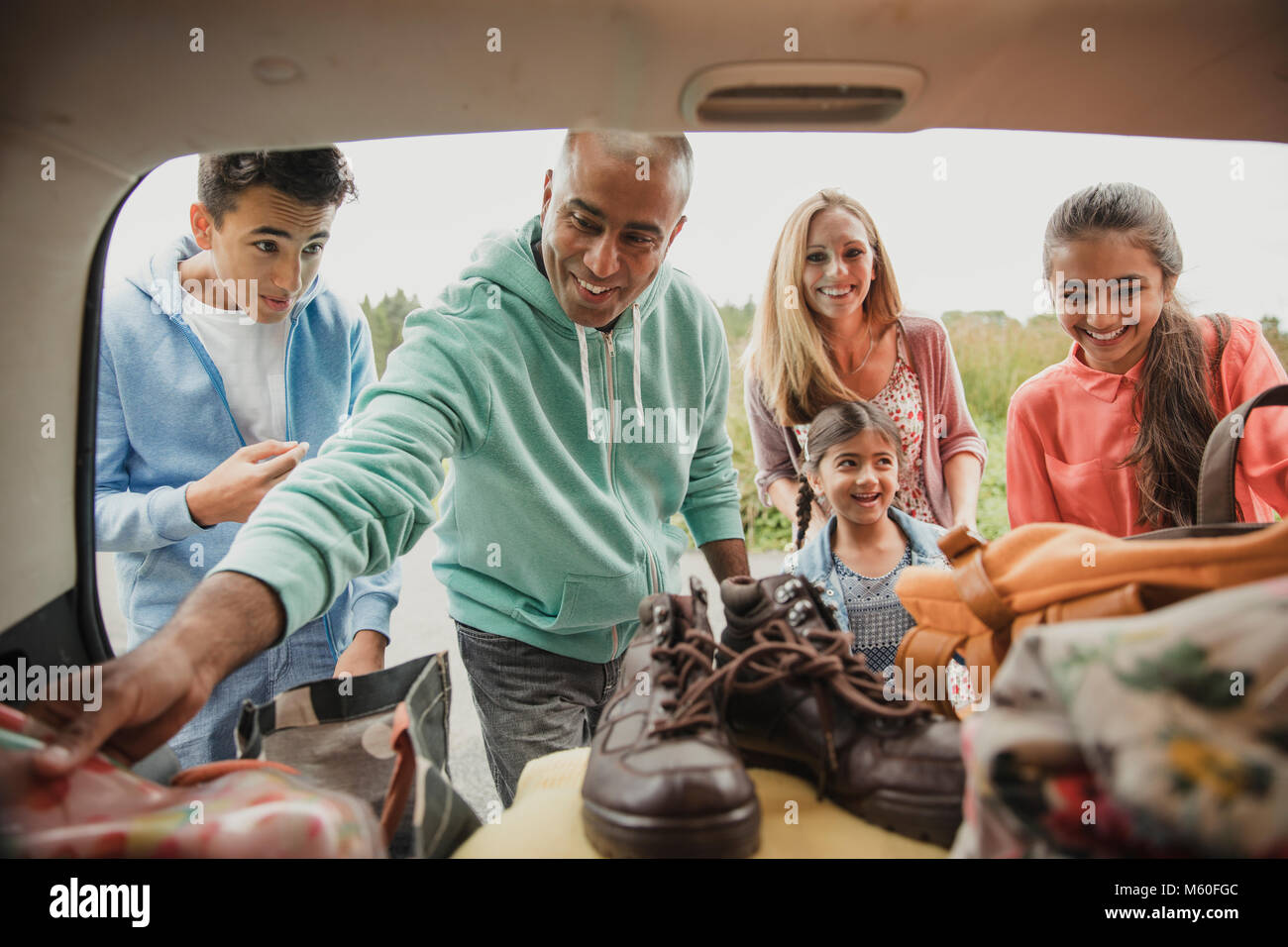 Inside view of car boot as family unpack the car Stock Photo - Alamy