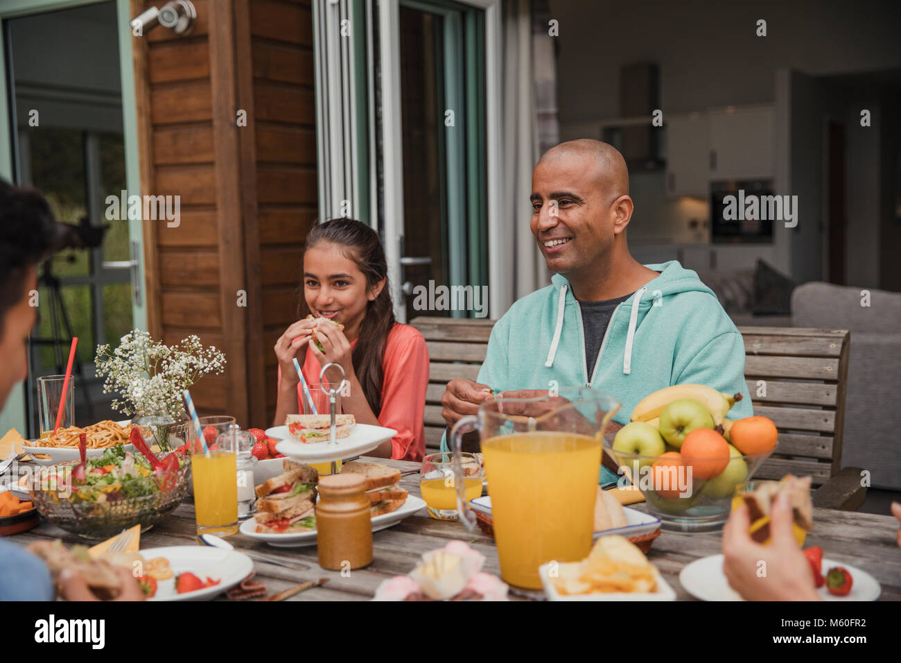 Family having brunch outside, eating a sandwich Stock Photo - Alamy