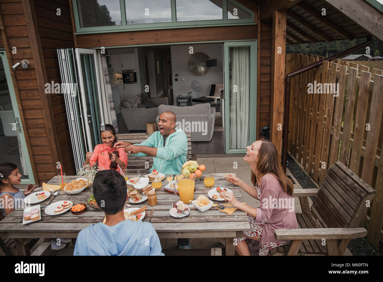 Family laughing and having fun during their brunch on vacation Stock ...