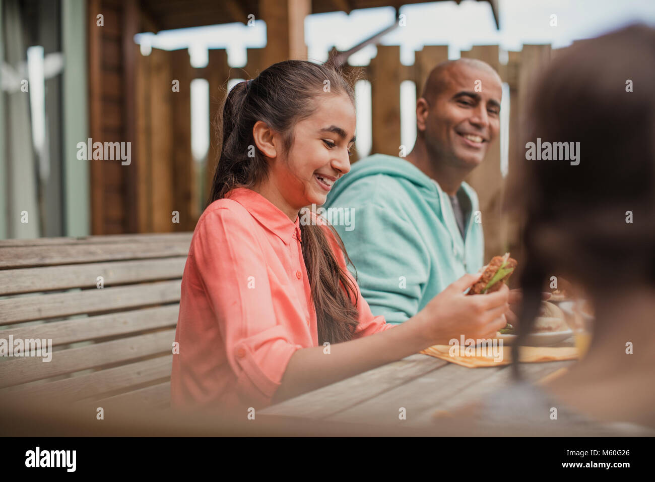 Young mixed race girl laughing at the table during brunch Stock Photo ...