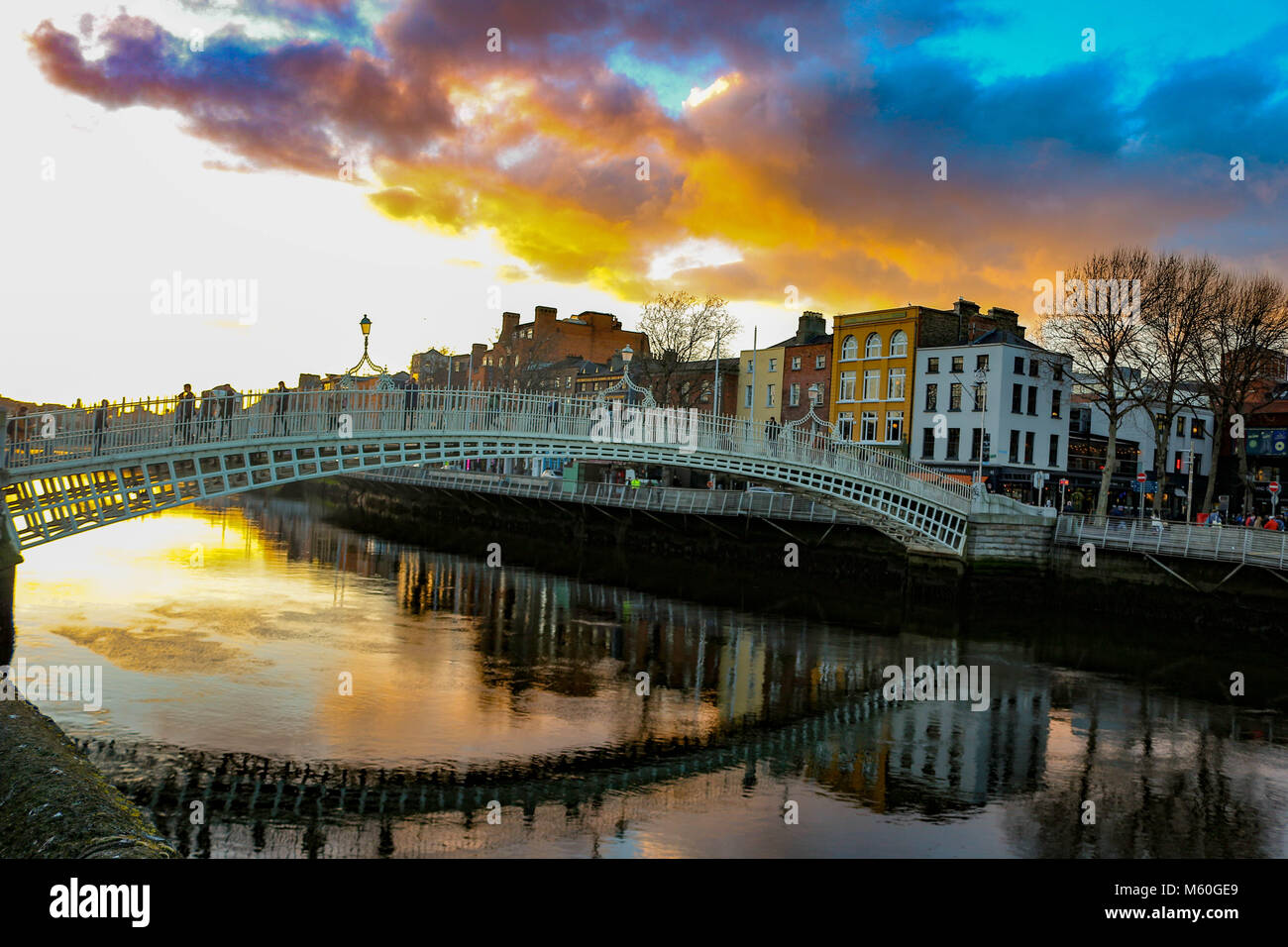 Dublin night scene with Ha'penny bridge and Liffey river lights ...