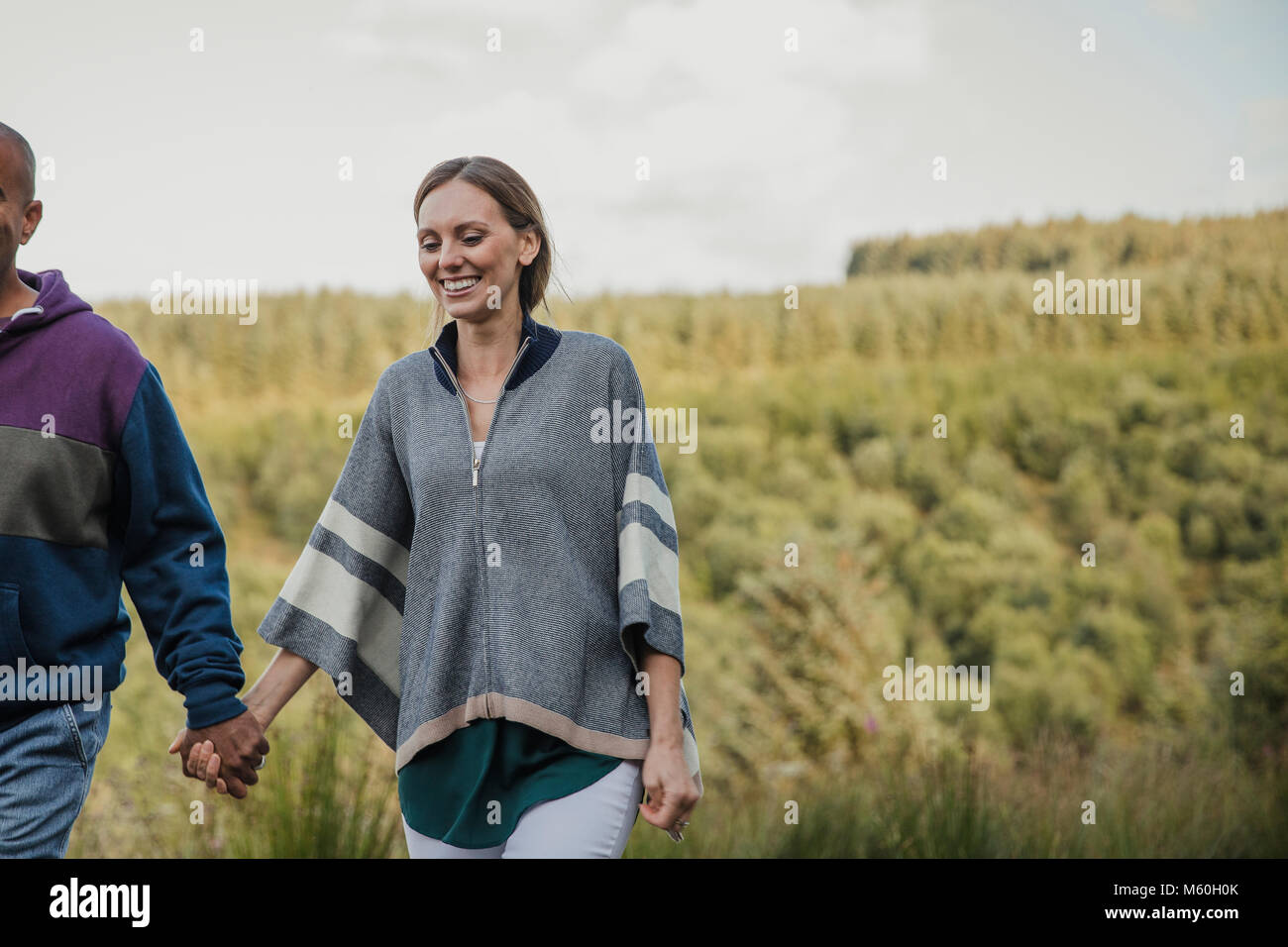 Happy Couple taking a walk together in the country side Stock Photo - Alamy