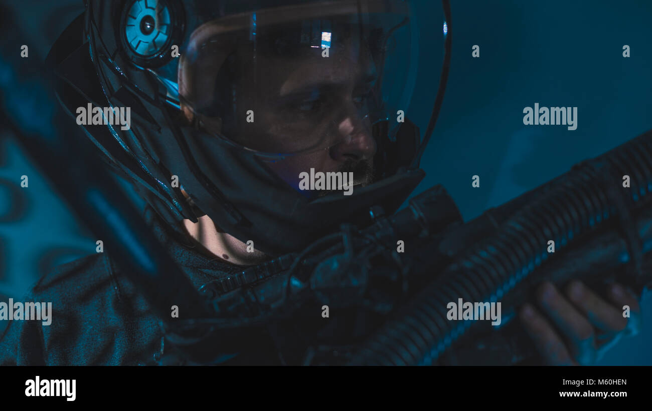 Mission, space man with led lights helmet, space suit and gun in the ...