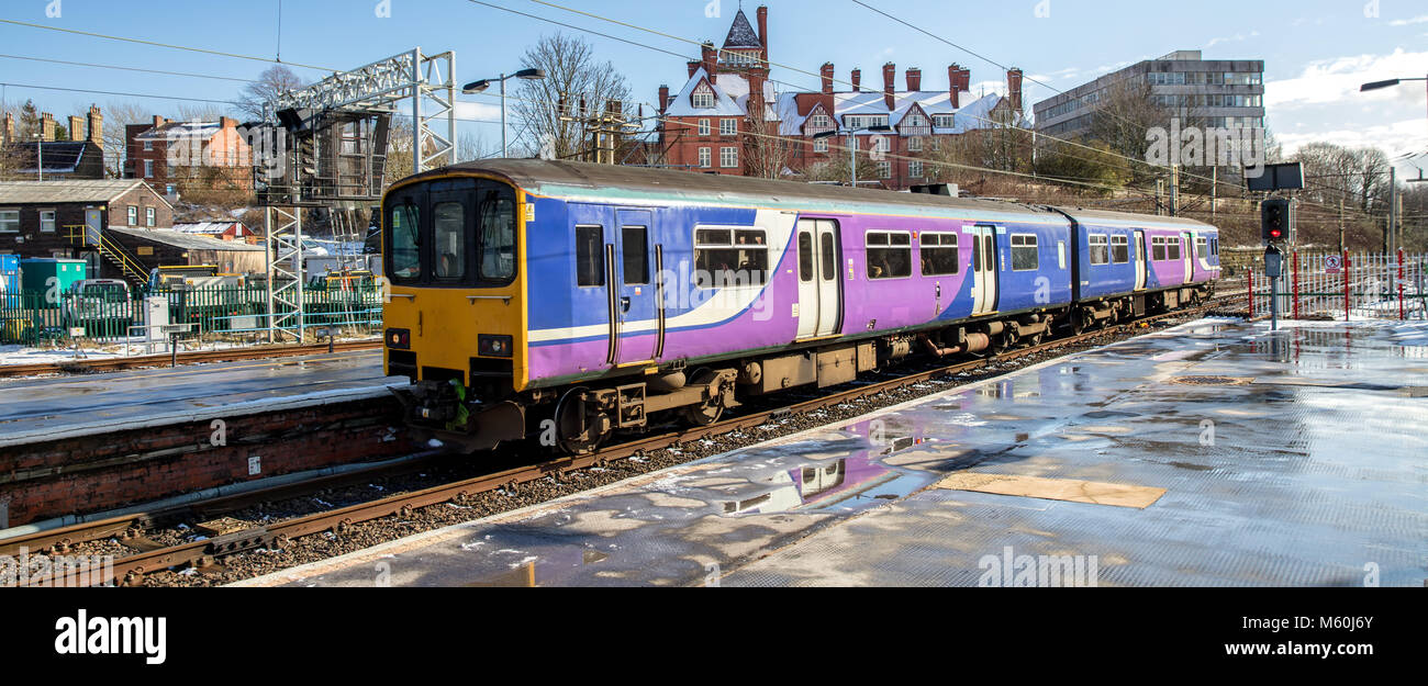 Blue, purple and white commuter train arrives at the station Stock ...