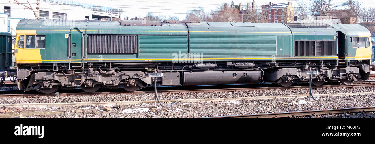 Green and yellow freight train Stock Photo - Alamy