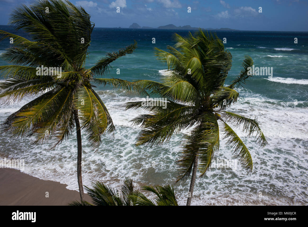 Waves break on a beach below the Petite Anse Hotel in Sauteurs, Grenada ...
