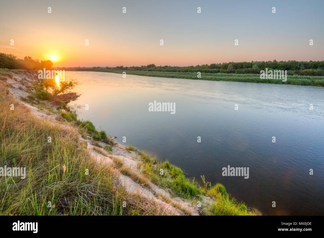 Bright orange sunset over the river in summer Stock Photo - Alamy