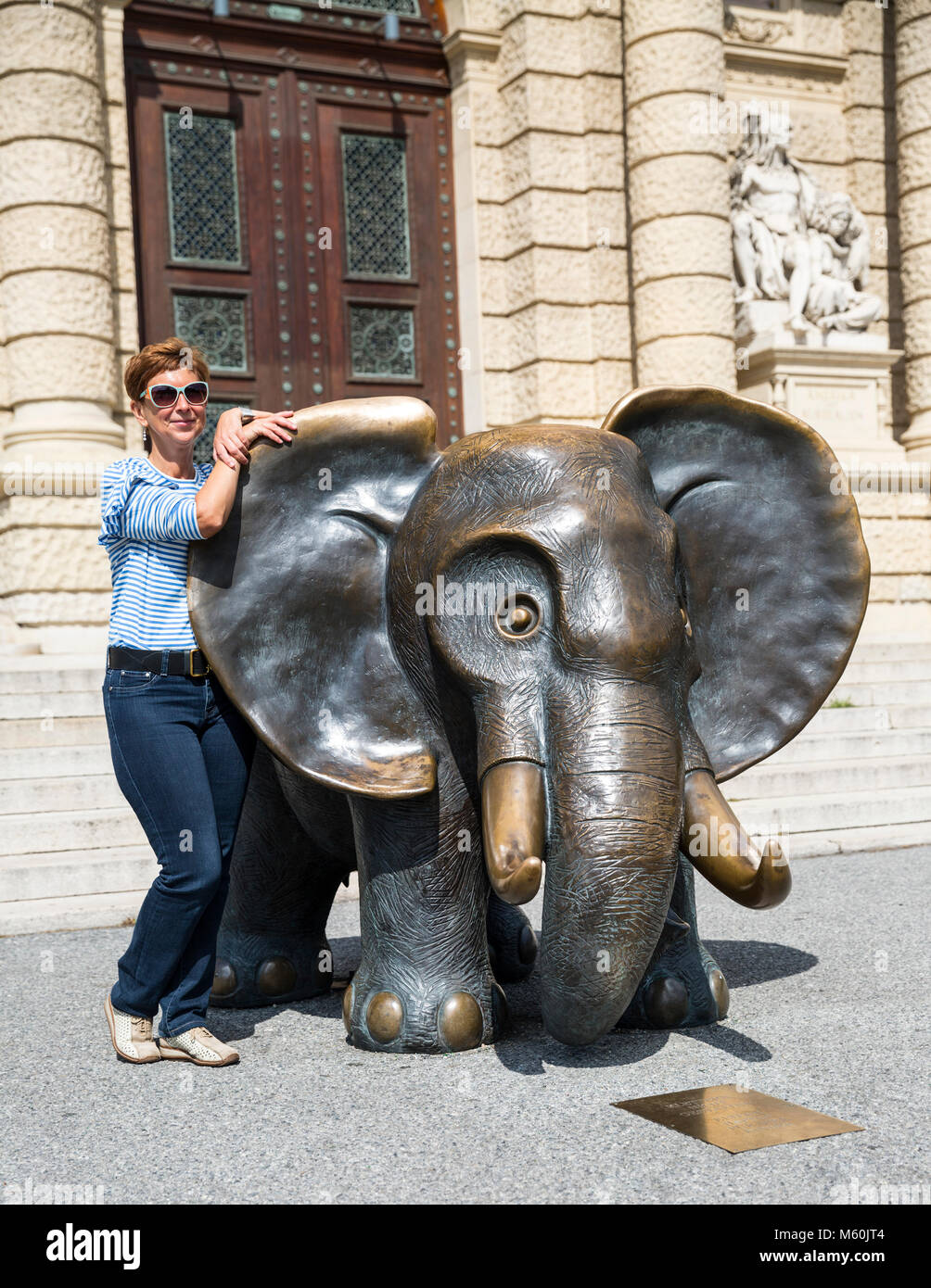 Tourist with Bronze African elephant sculpture by Prof Gottfried Kumpf ...