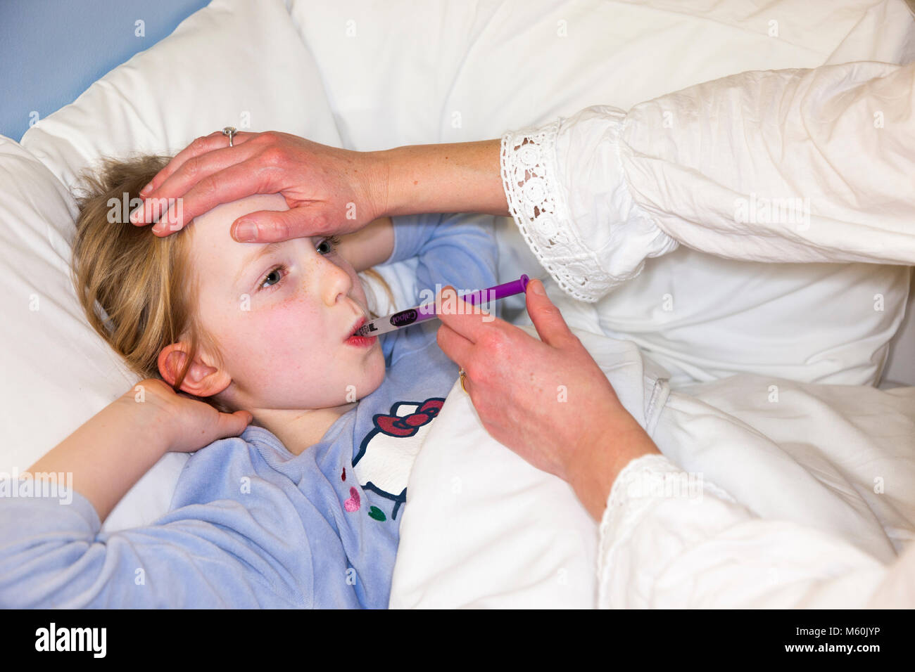 Mother / mum / mom giving Calpol medicine with paracetamol to – an ...