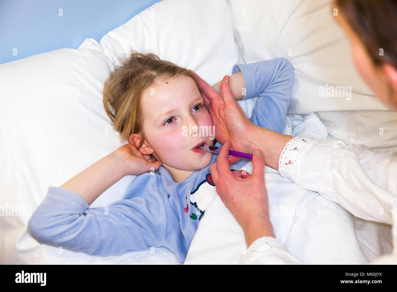 Mother / mum / mom giving Calpol medicine with paracetamol to – an ...