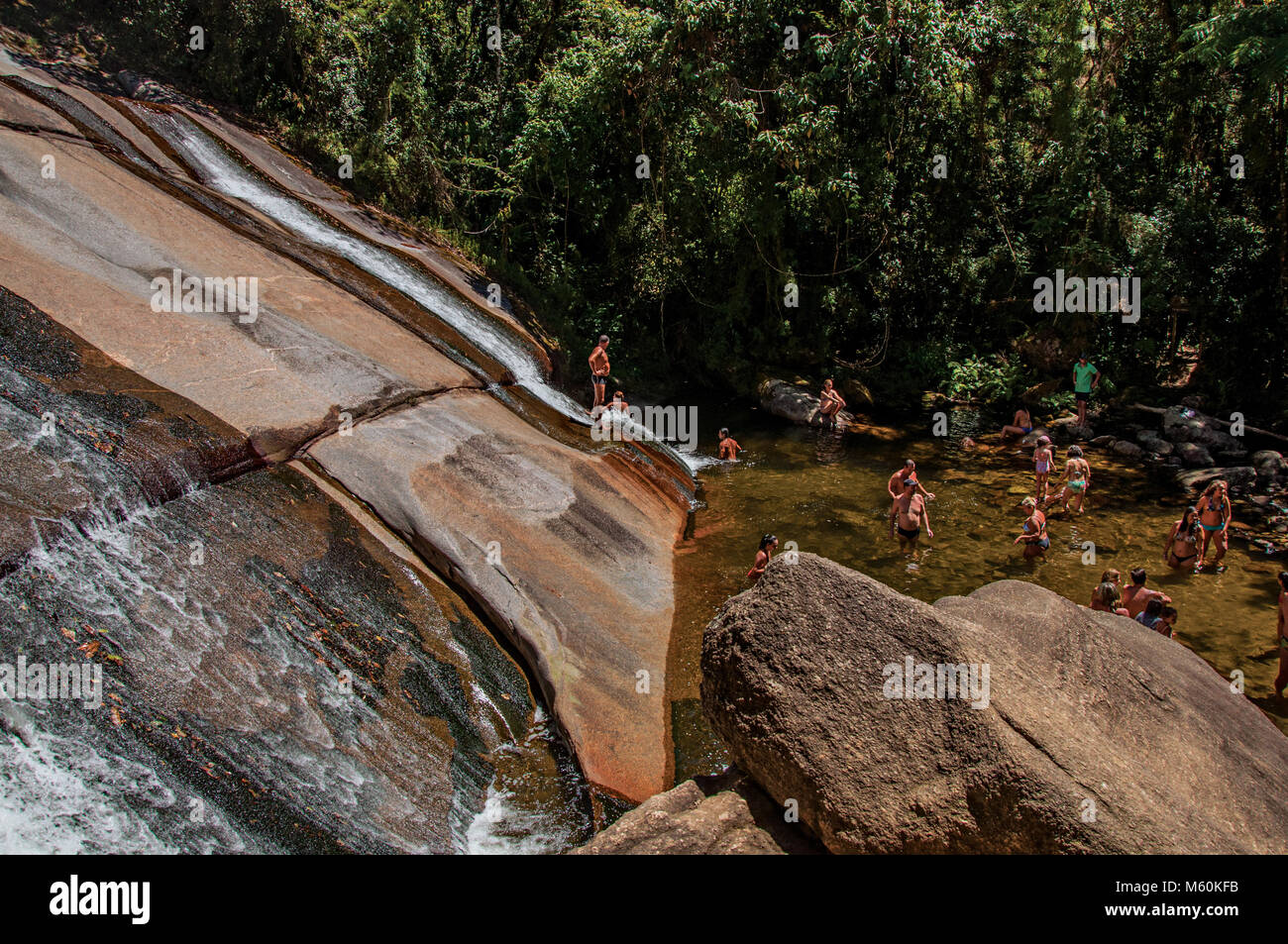 Visconde de Maua, Brazil. View of waterfall and people in a forest at ...