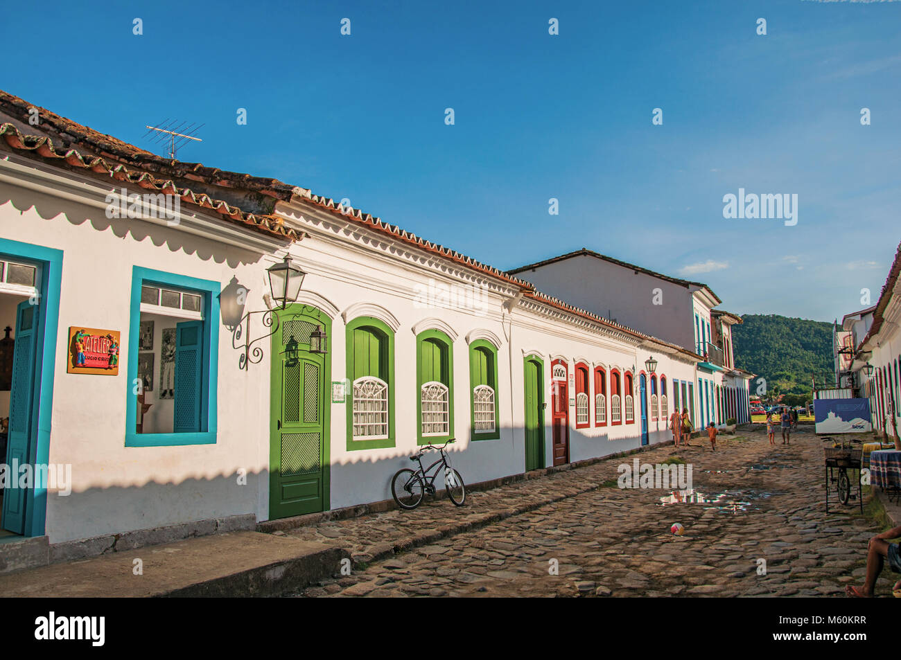 Paraty, Brazil. Cobblestone street with houses under blue sunny sky in ...