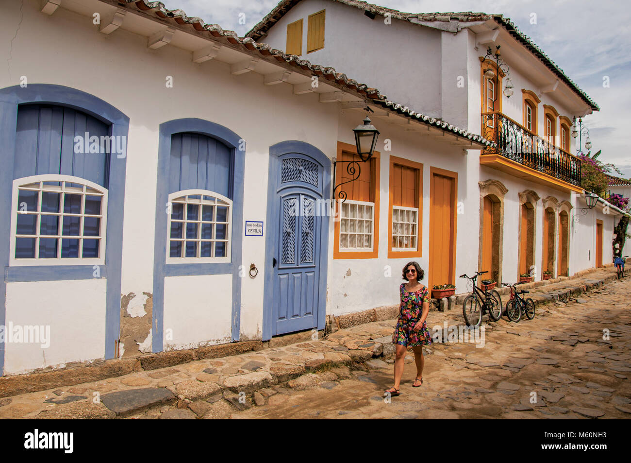 Paraty, Brazil. Cobblestone alley with colorful old houses and woman in ...