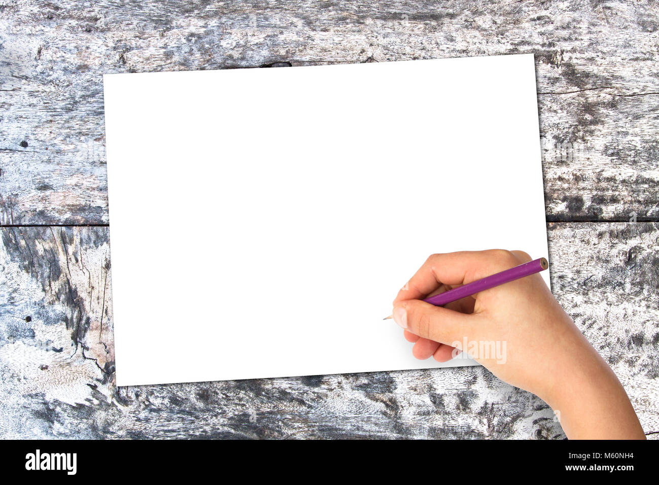 white sheet of paper on the oak brown table with hand Stock Photo - Alamy