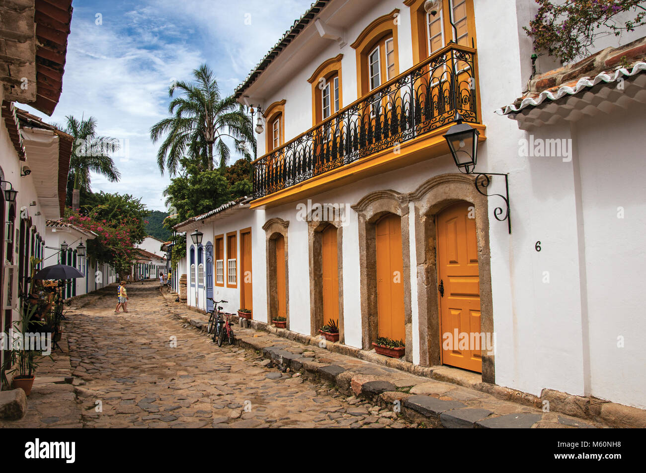 Paraty, Brazil. Cobblestone alley with colorful houses and bicycle in ...