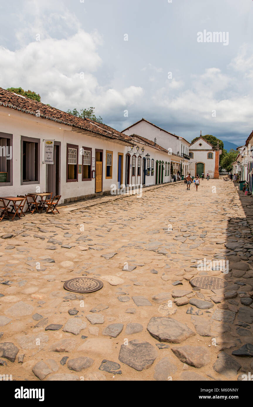 Paraty, Brazil. Cobblestone street with old houses under blue cloudy ...