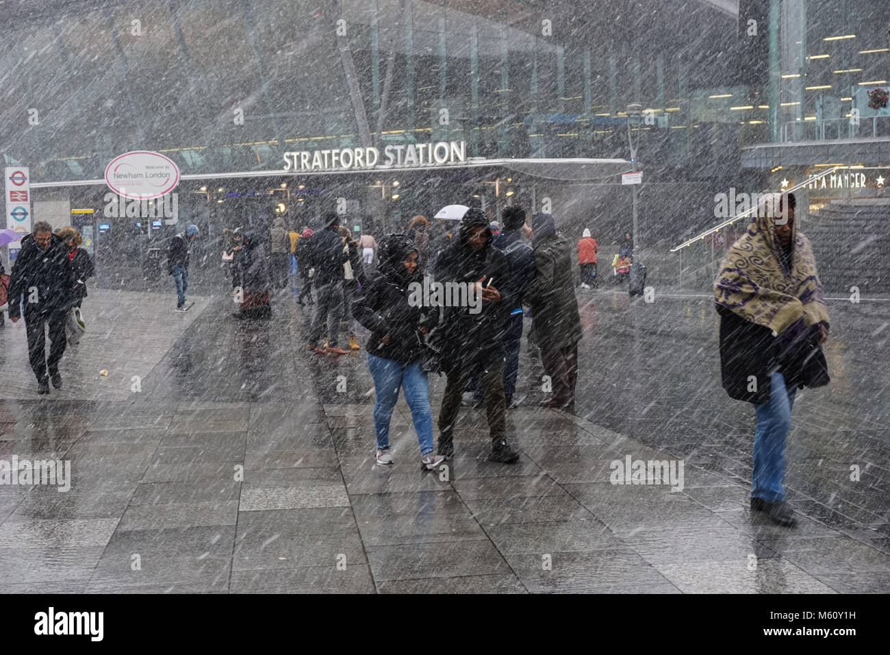People caught in heavy snowfall at Stratford in London, England, United ...