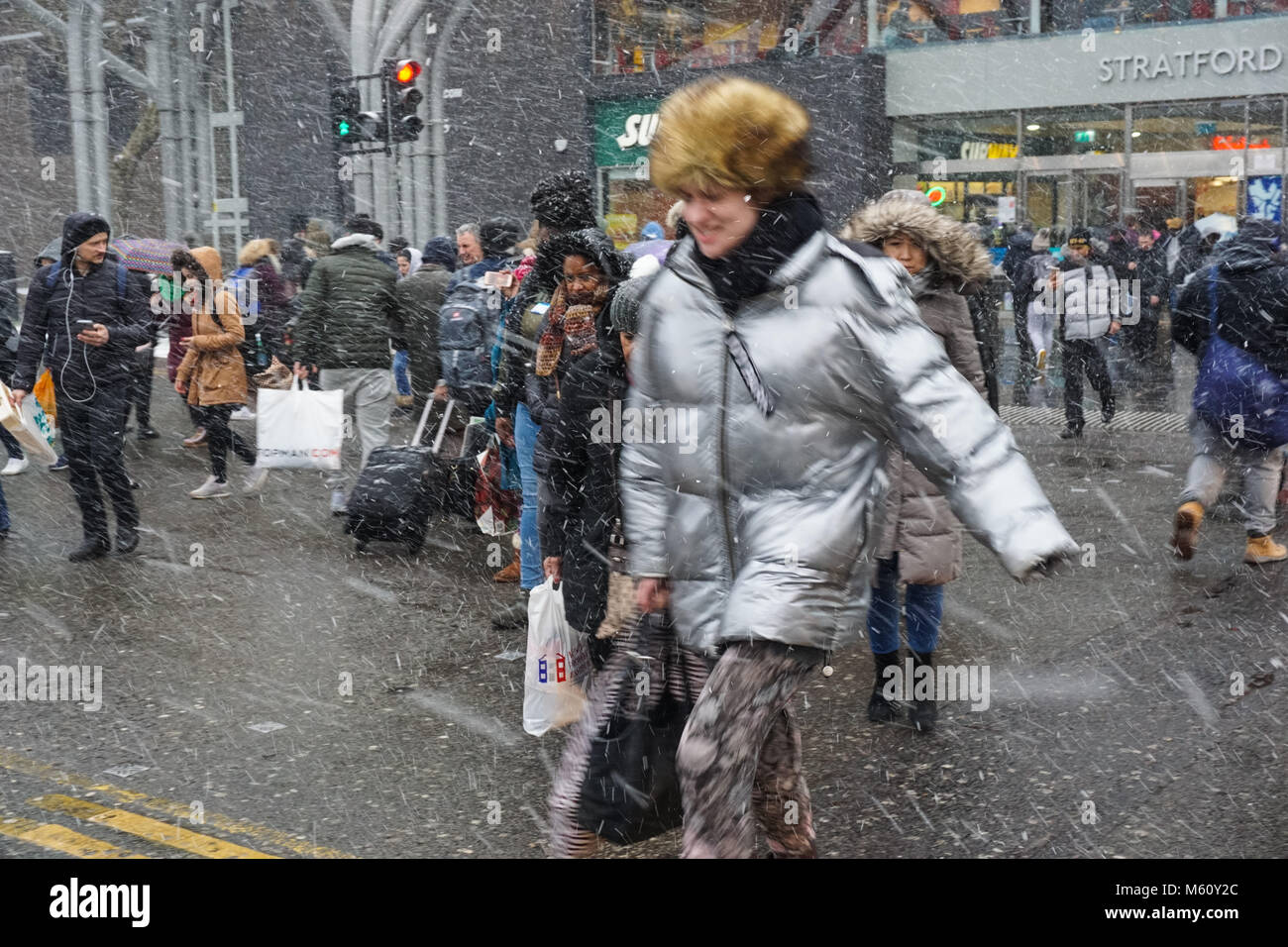 People caught in heavy snowfall at Stratford in London, England, United ...
