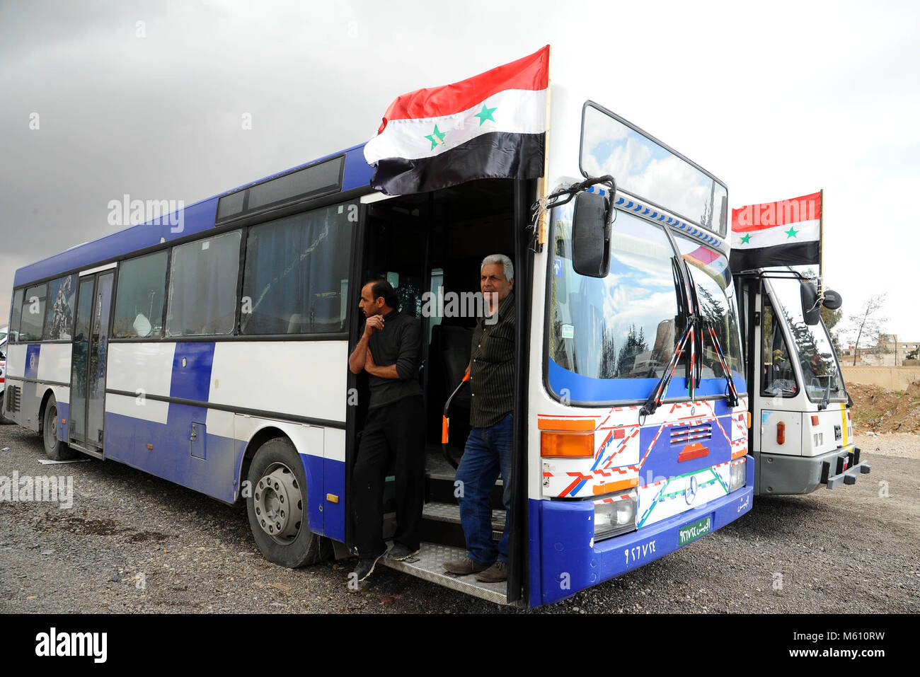 Damascus, Syria. 27th Feb, 2018. Syrian government buses wait at a ...