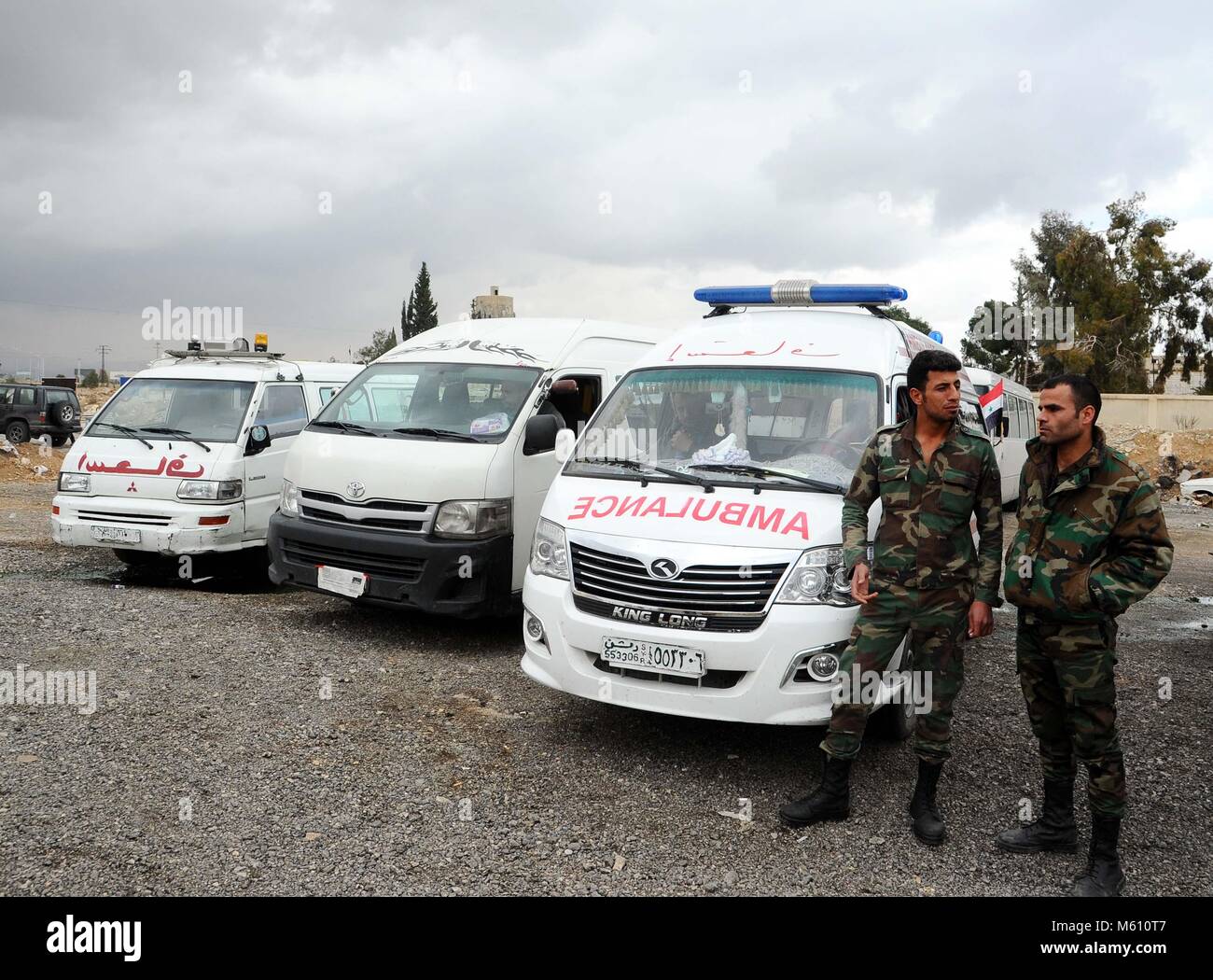 Damascus, Syria. 27th Feb, 2018. Syrian Red Crescent ambulances wait at ...