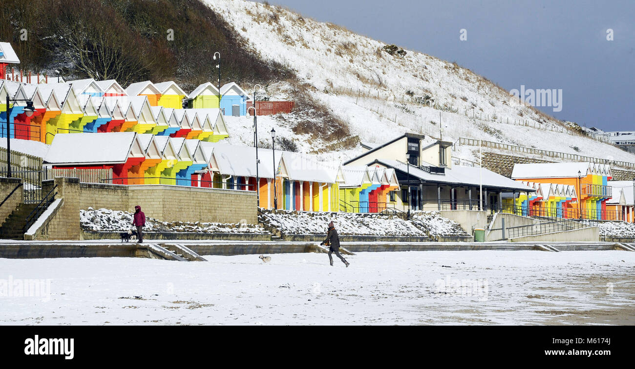 Snow covered beach huts at Scarborough North Bay beach, as heavy ...