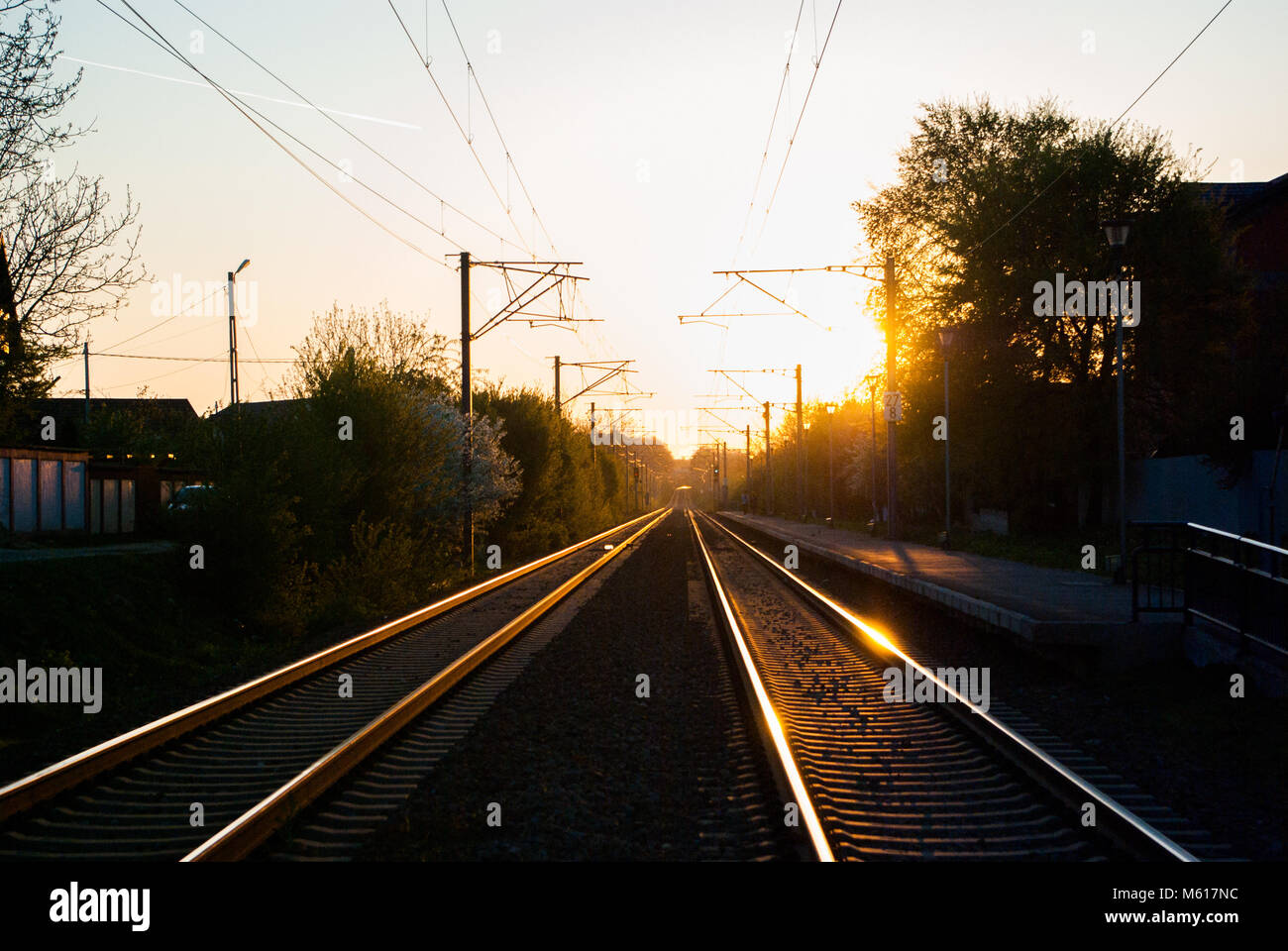 Railway sunset, Bucharest to Constanta, Romania, rural station Stock ...