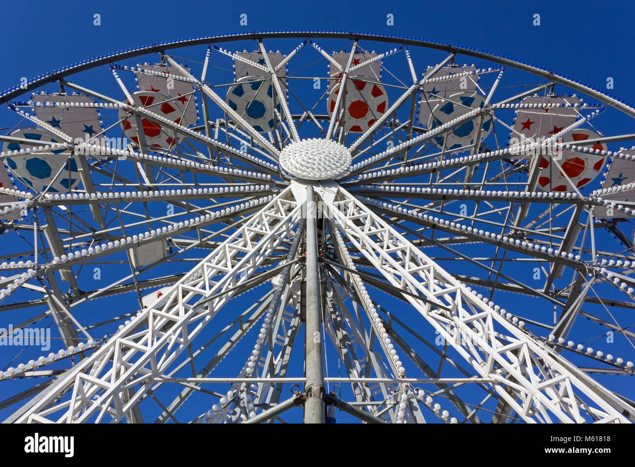 Ferris wheel decorated in red and blue against a blue sky Stock Photo ...