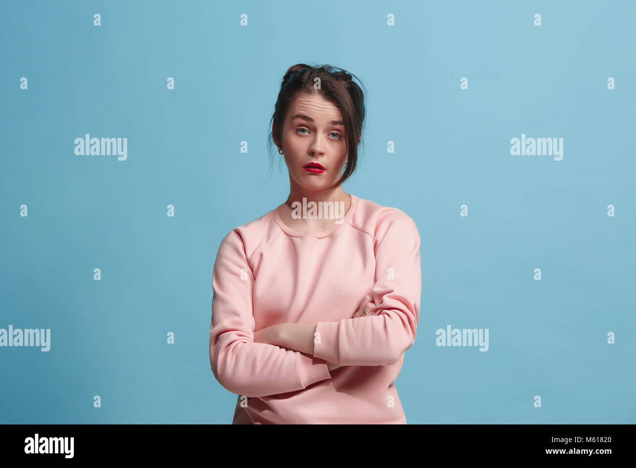 Beautiful bored woman bored isolated on blue background Stock Photo - Alamy