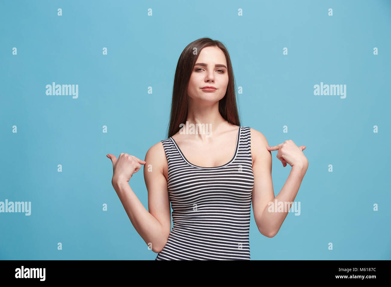 The satisfy woman standing on the blue background Stock Photo - Alamy