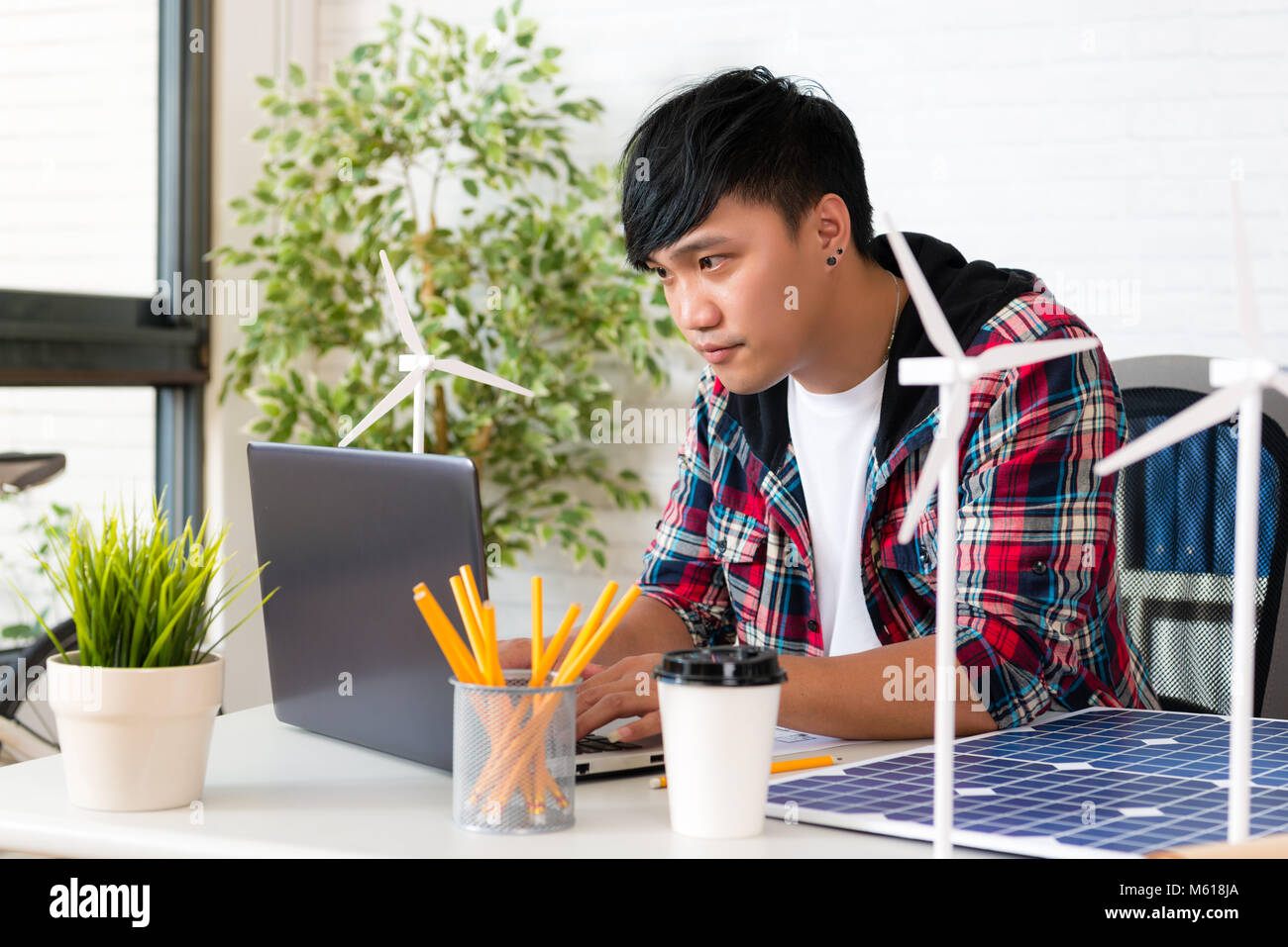 Handsome male alternative designer using computer to design new idea of ...