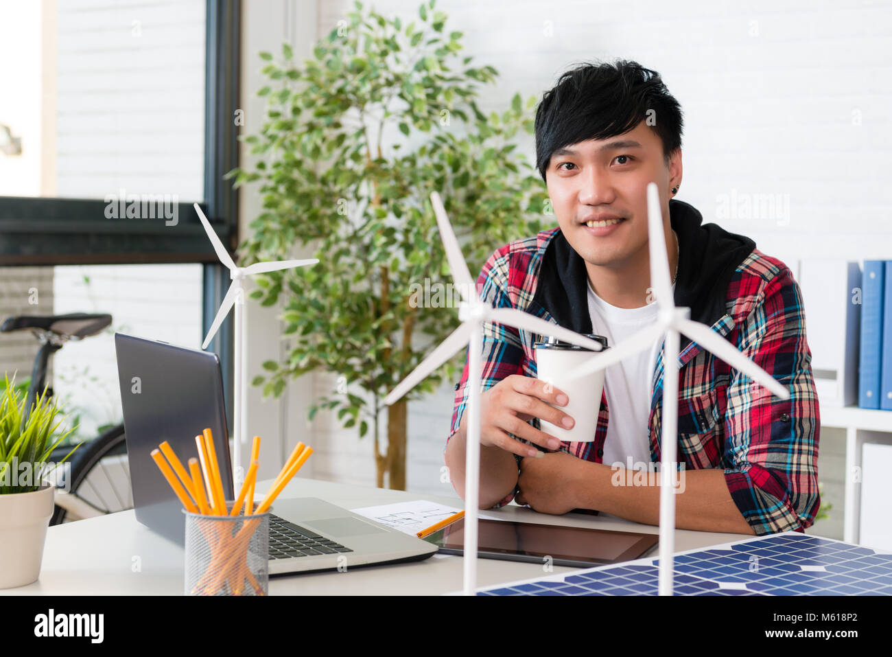 successful man alternative energy engineer holding and drinking coffee ...