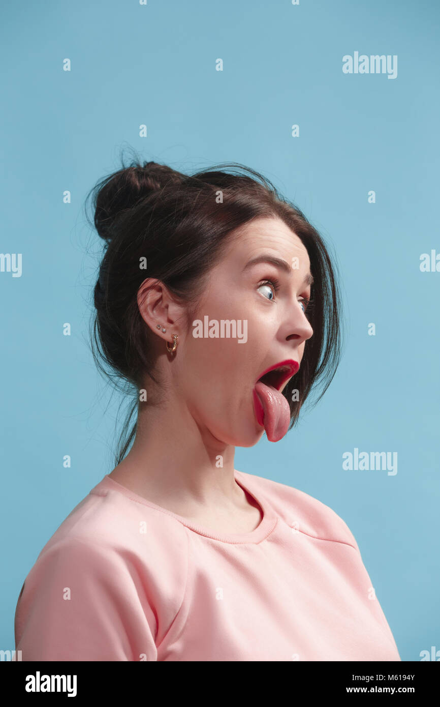 The squint eyed woman with weird expression isolated on blue Stock ...