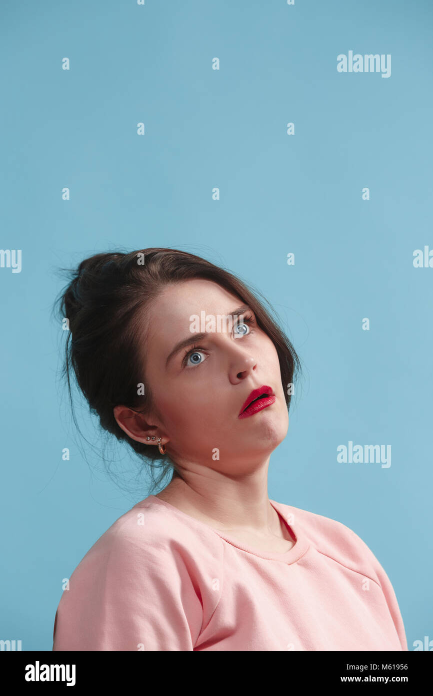 Beautiful bored woman bored isolated on blue background Stock Photo - Alamy